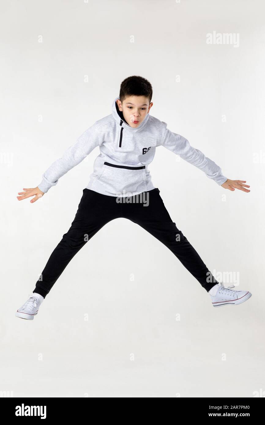emotional little boy jumping on white studio background Stock Photo - Alamy