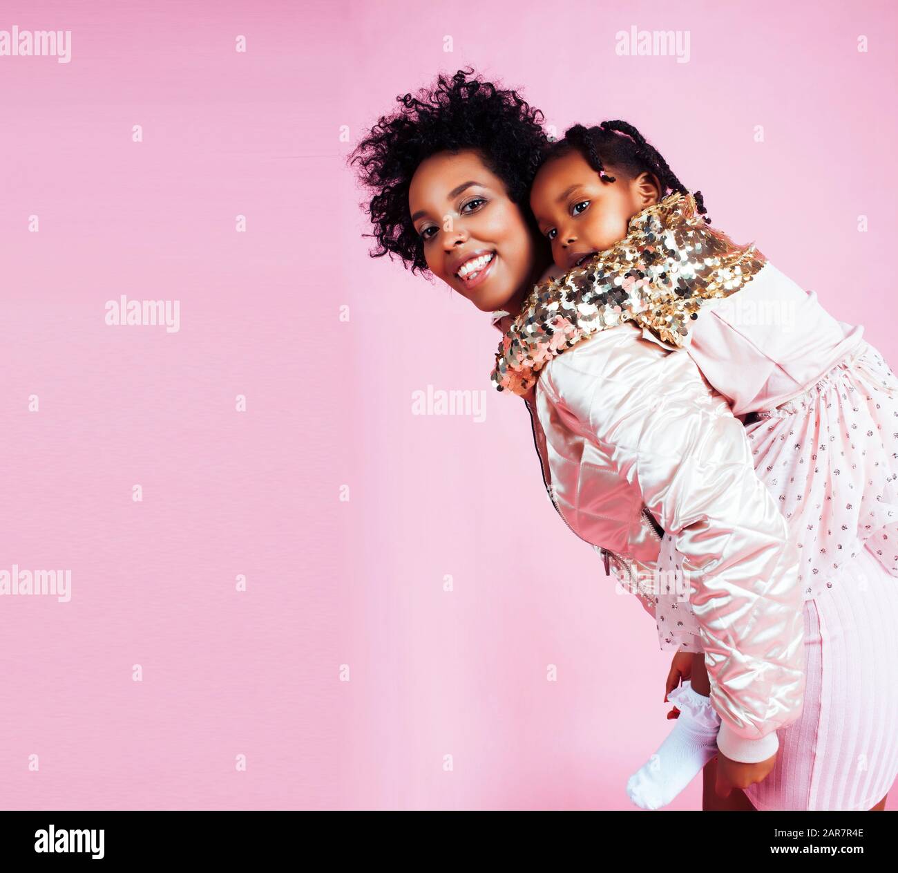 young pretty african-american mother with little cute daughter hugging ...