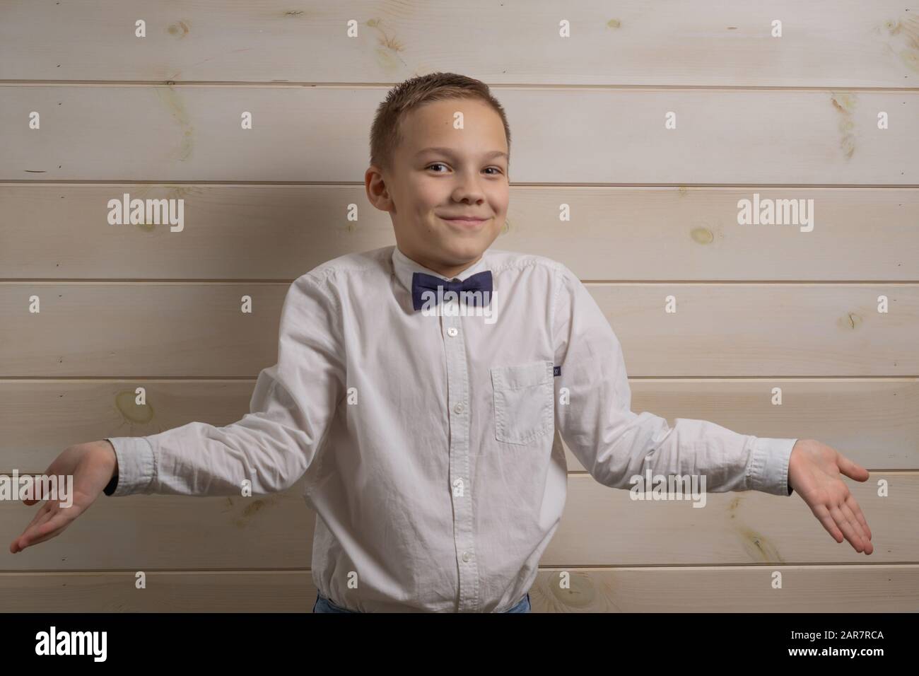 A fair-haired boy of 10 years in a white shirt with the self-tie bow ...