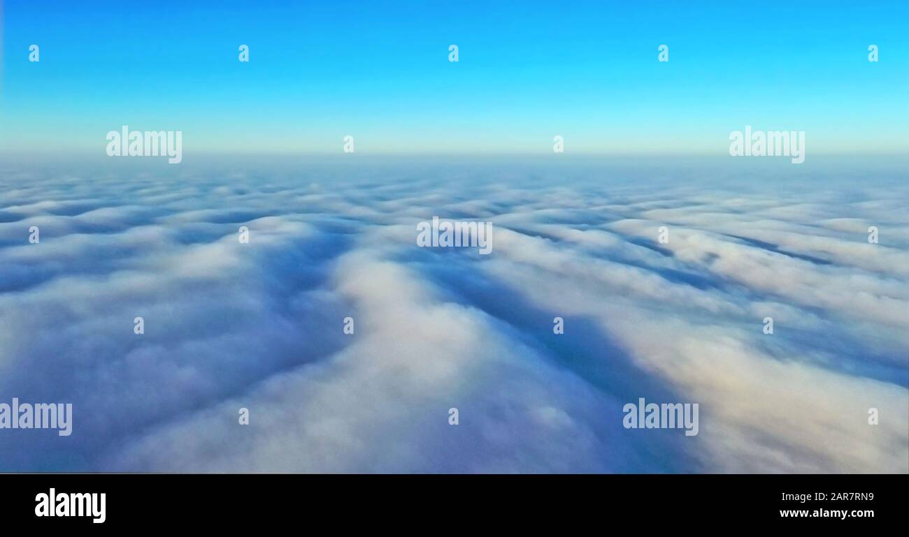 Aerial photos, cover of thick gray clouds in the bright sun in the blue ...