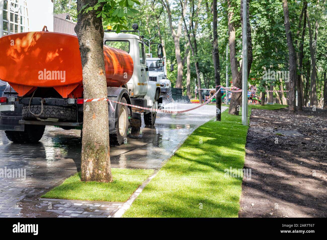 Straigh line border of new freshly installed green rolled lawn grass ...