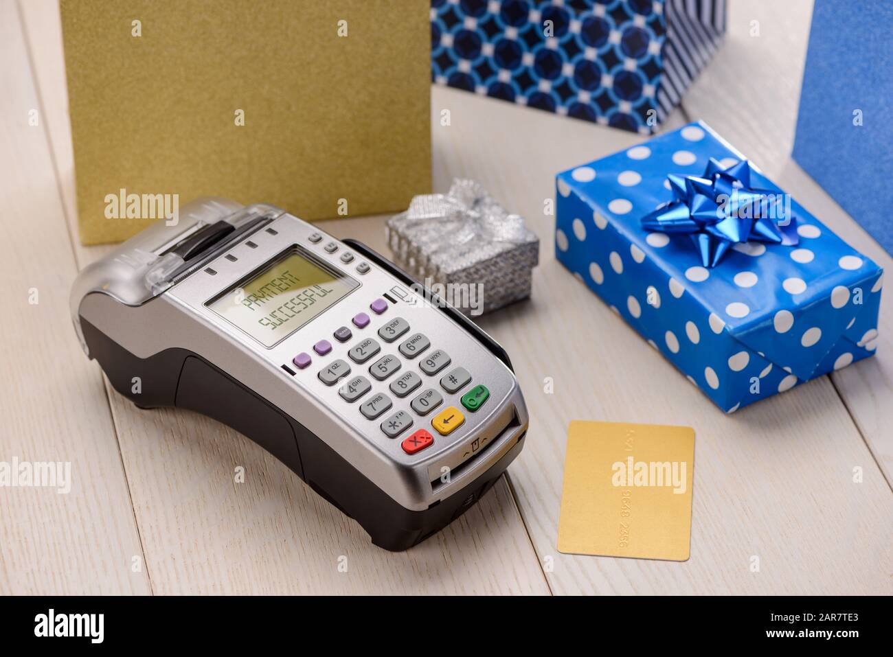 Card reader, gift boxes and pockets on a wooden cash desk Stock Photo ...
