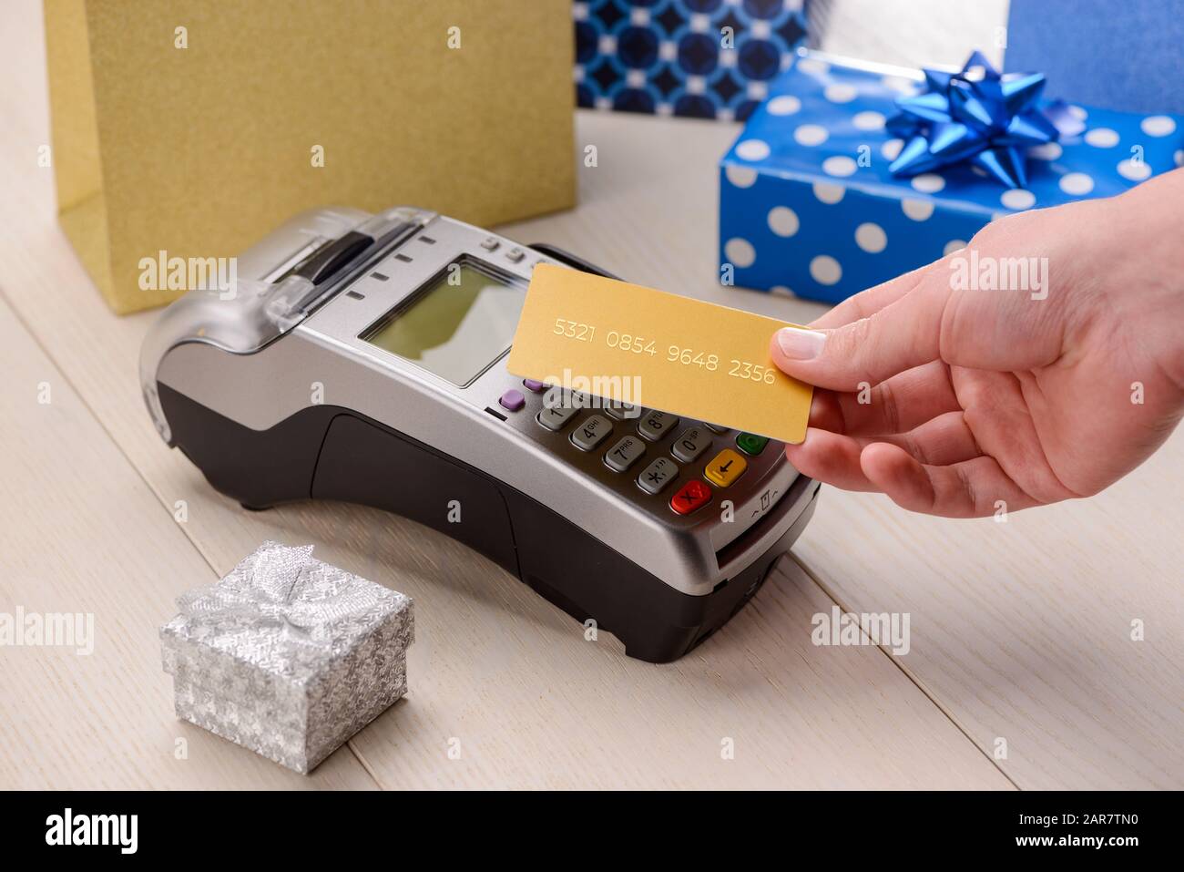 Customer paying for luxury gifts with a golden credit card Stock Photo ...