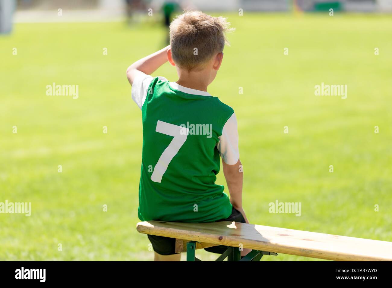 Boy in soccer uniform sitting hi-res stock photography and images - Alamy
