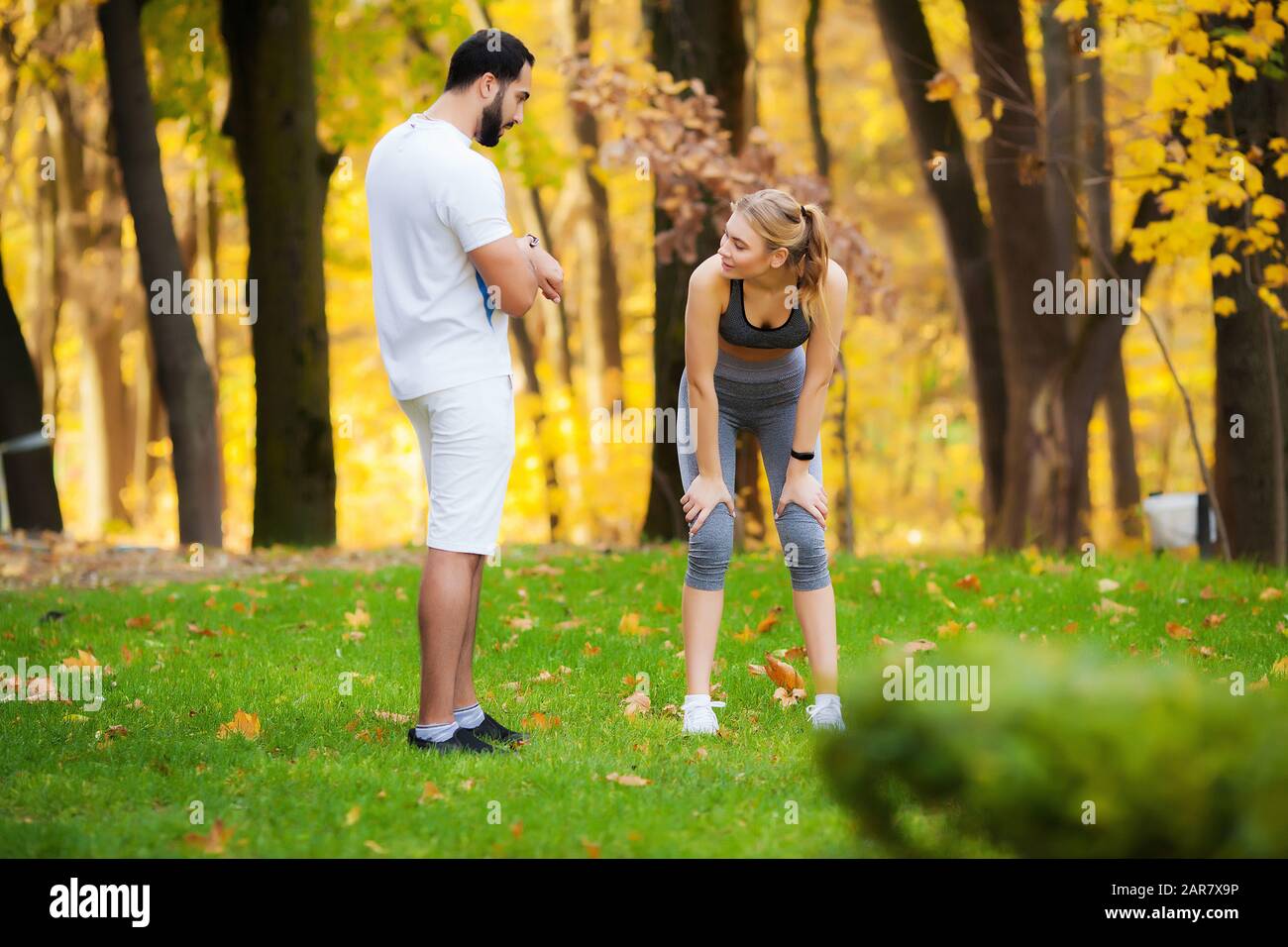 Fitness. Personal Trainer Takes Notes While Woman Exercising Outdoor ...