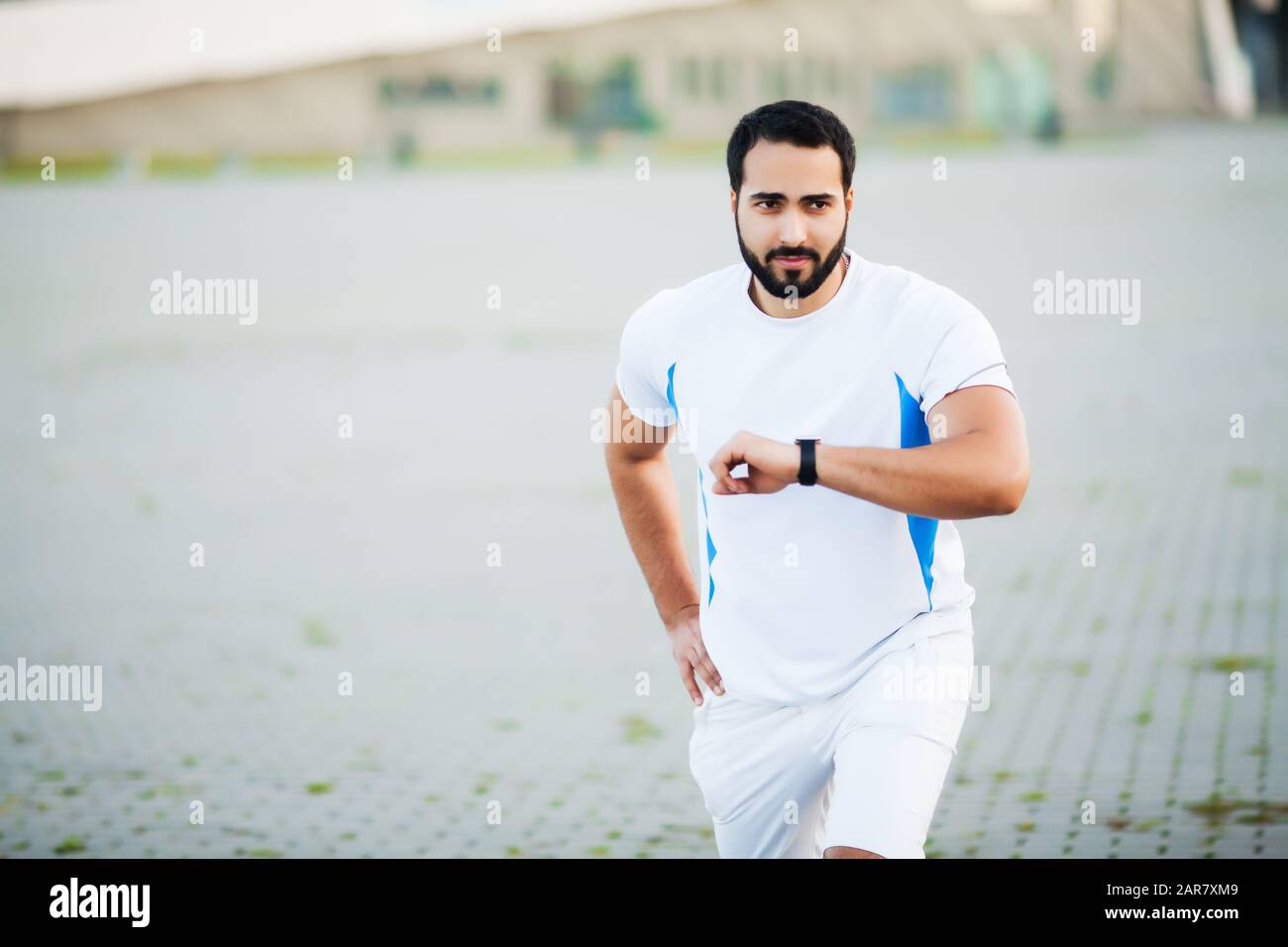 Fitness. Young man running in urban environment Stock Photo - Alamy