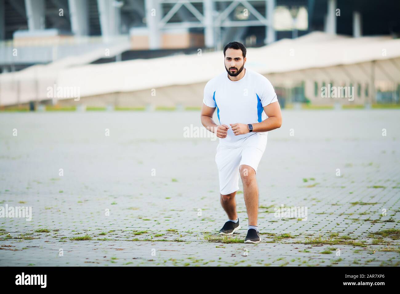 Fitness. Young man running in urban environment Stock Photo - Alamy
