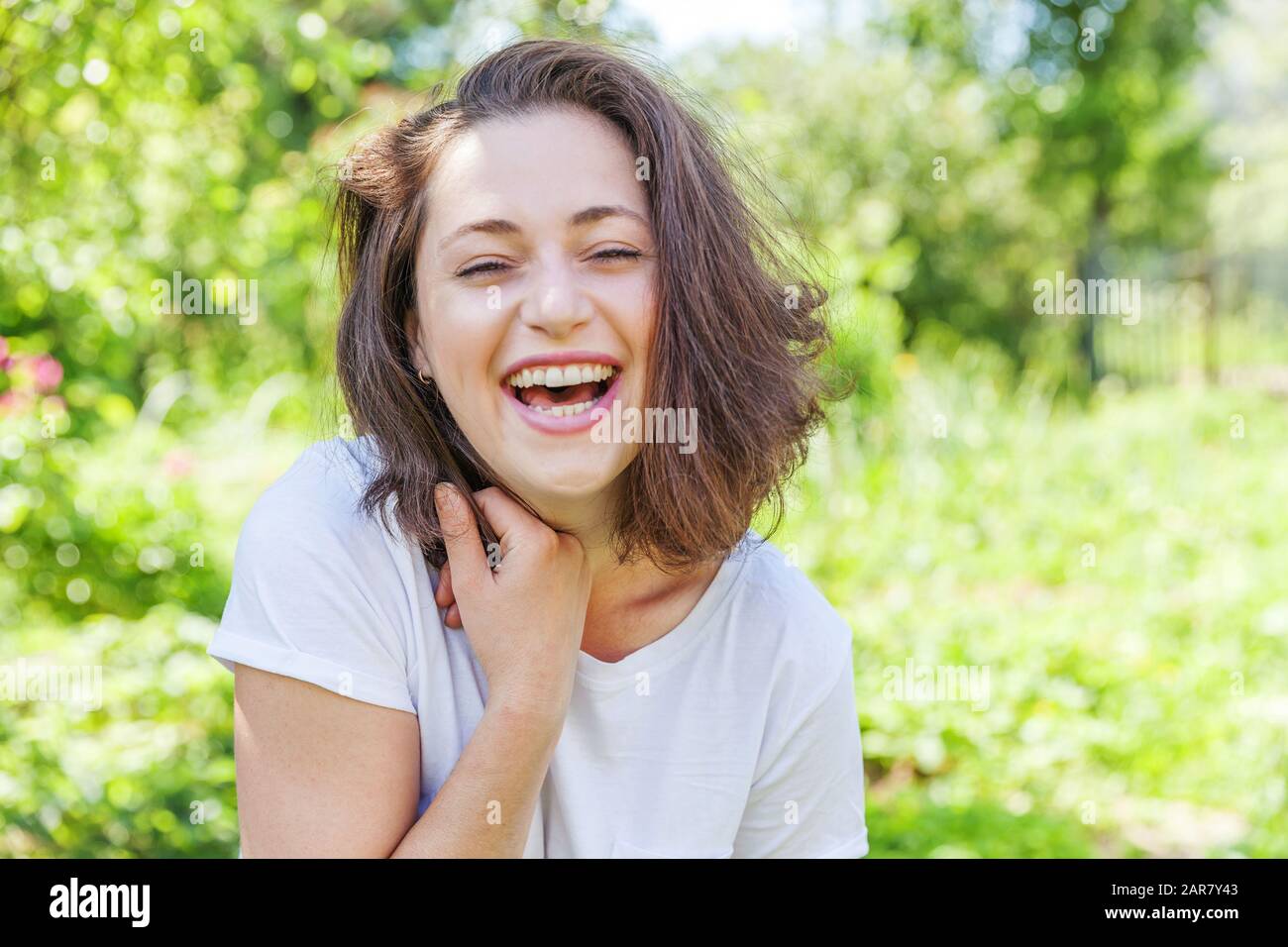 Happy girl smiling outdoor. Beautiful young brunete woman with brown ...