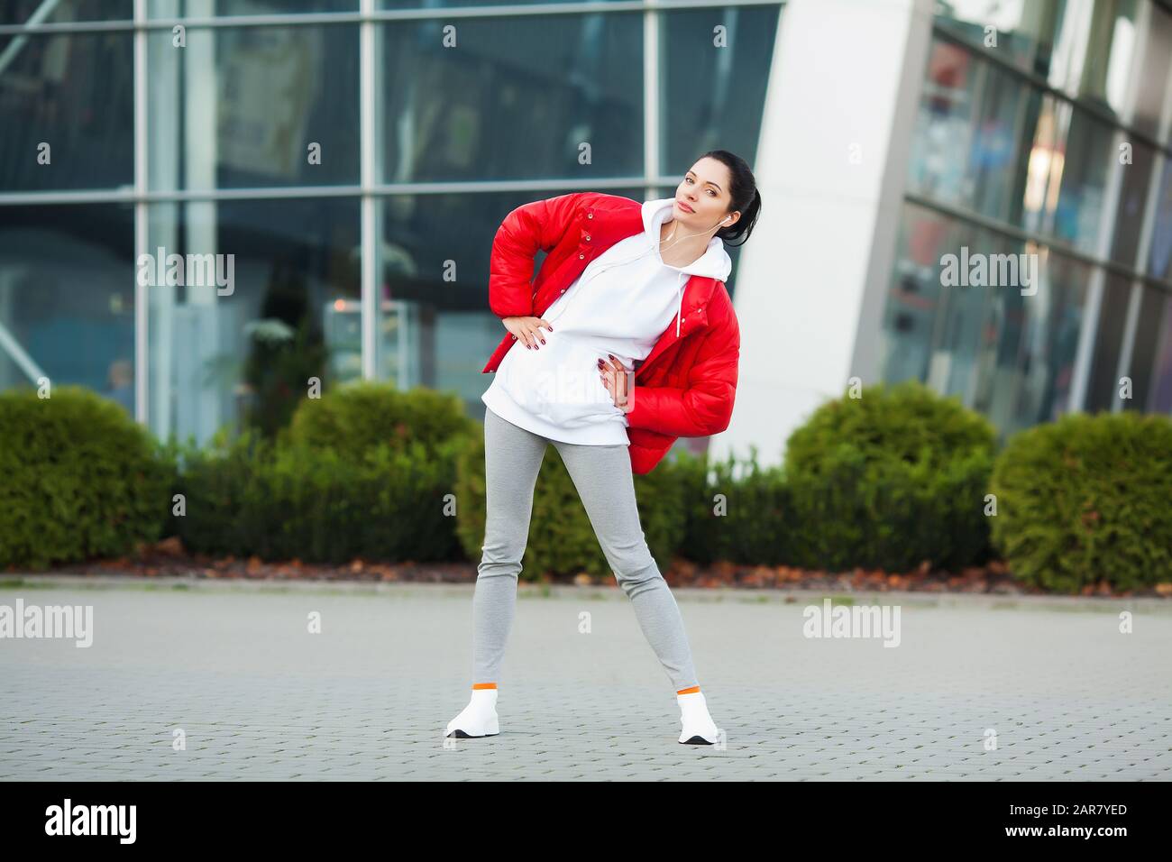 Fitness woman doing workout standing in a stadium background Stock ...