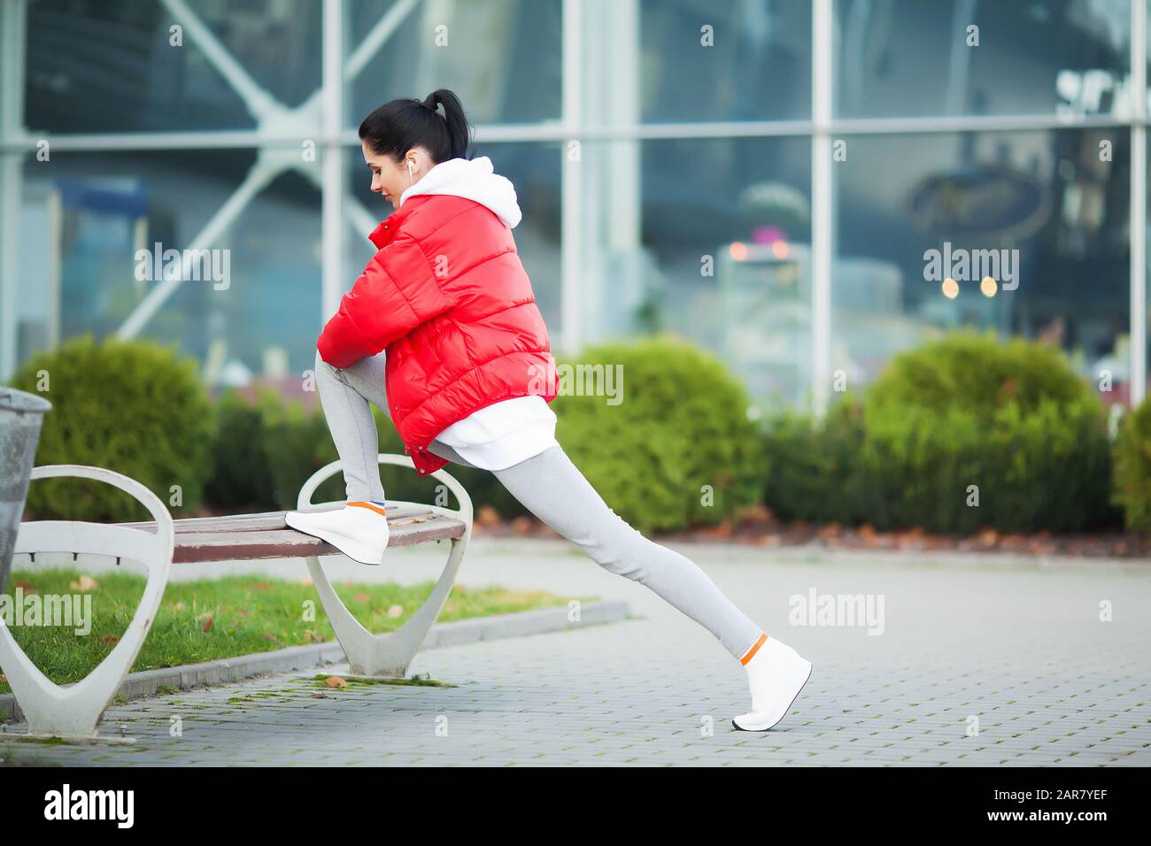 Fitness woman doing workout standing in a stadium background Stock ...