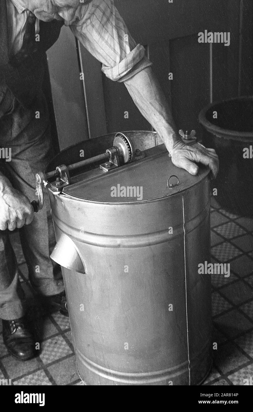 1950s, historical, making mead, a gentleman securing the lid of a large ...