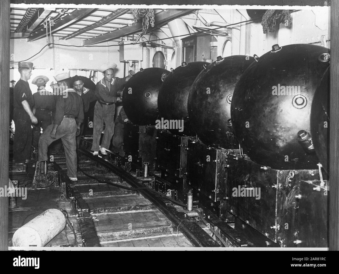 Mines ready to be laid in the Dutch-Indian waters aboard a mineslayer ...