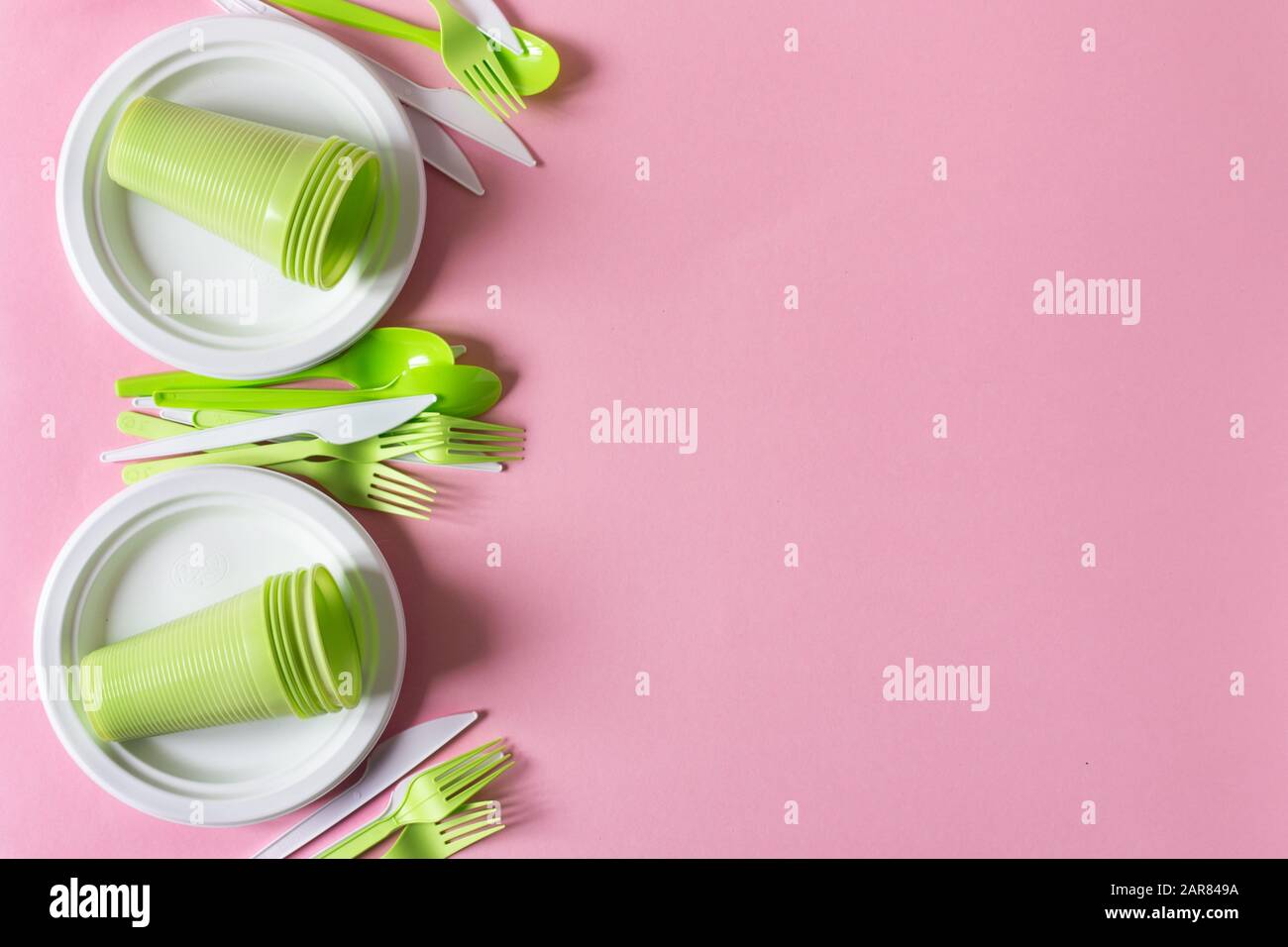 Plastic disposable dishes. Food plastic on pastel pink background top ...