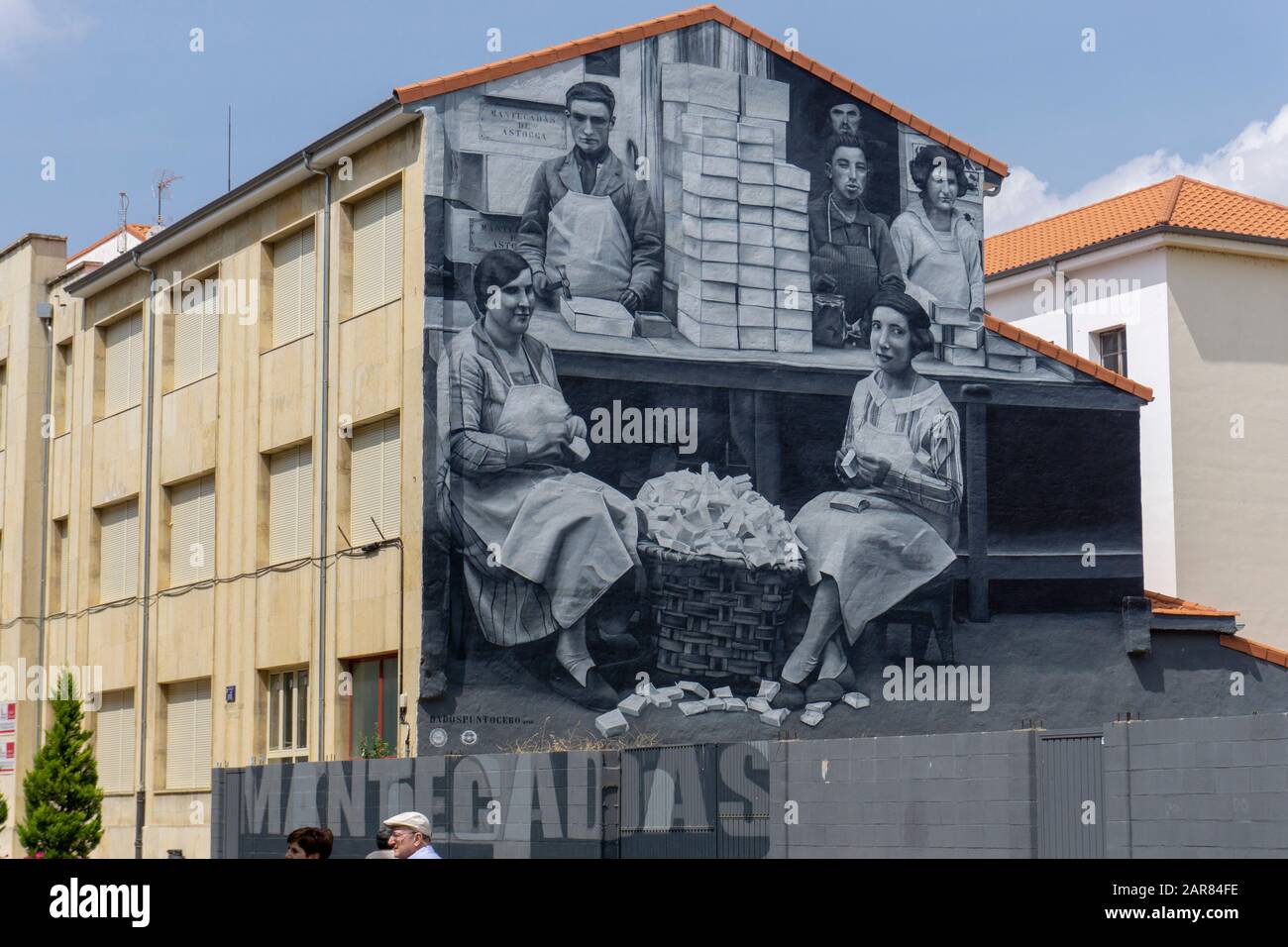 Large black and white mural depicting men and women working in a shop ...