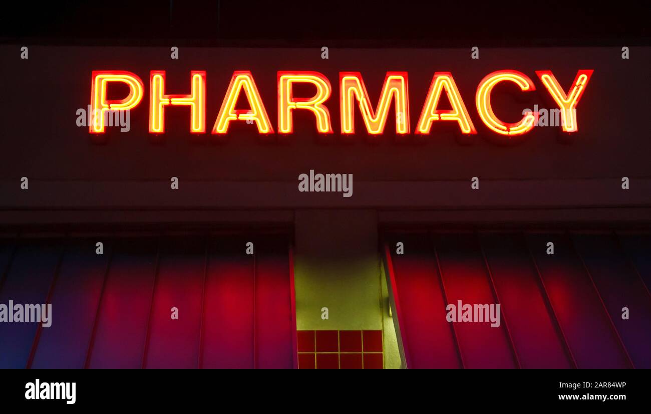 A neon sign over a pharmacy on a roof Stock Photo - Alamy