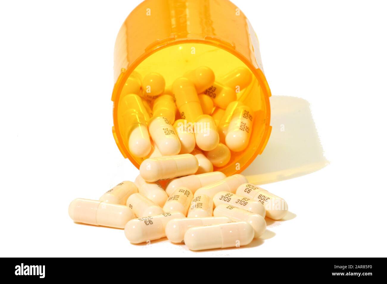 Pink pills in a bottle isolated against white Stock Photo - Alamy