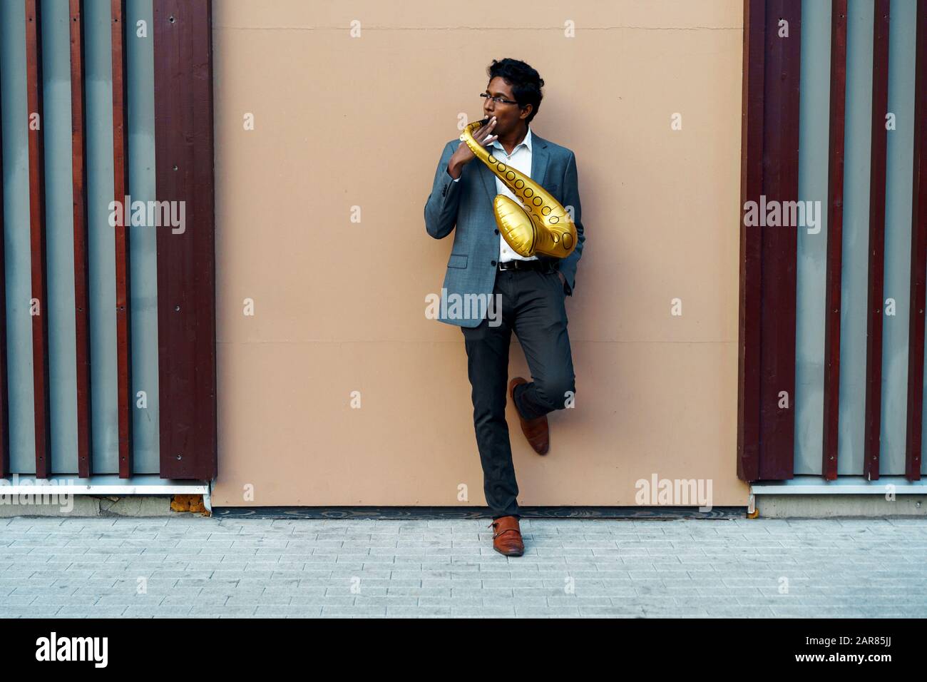 Funny handsome man with a golden color inflatable tube Stock Photo - Alamy