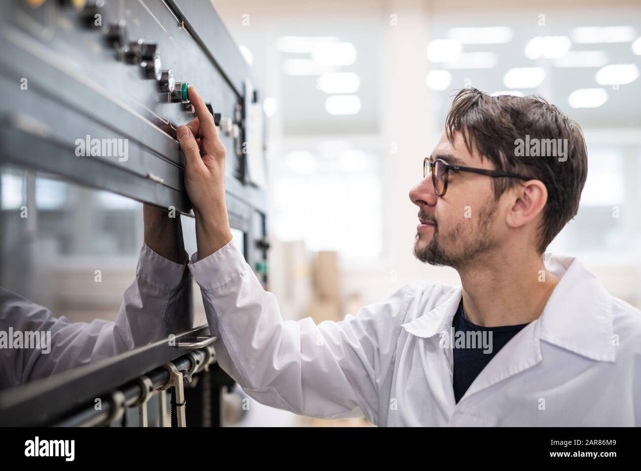 Young specialist working at factory Stock Photo - Alamy