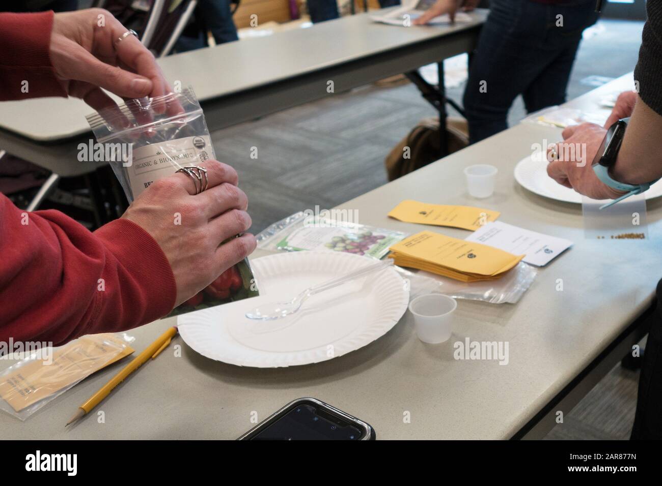 People select seeds to take home at the opening of the seed sharing ...