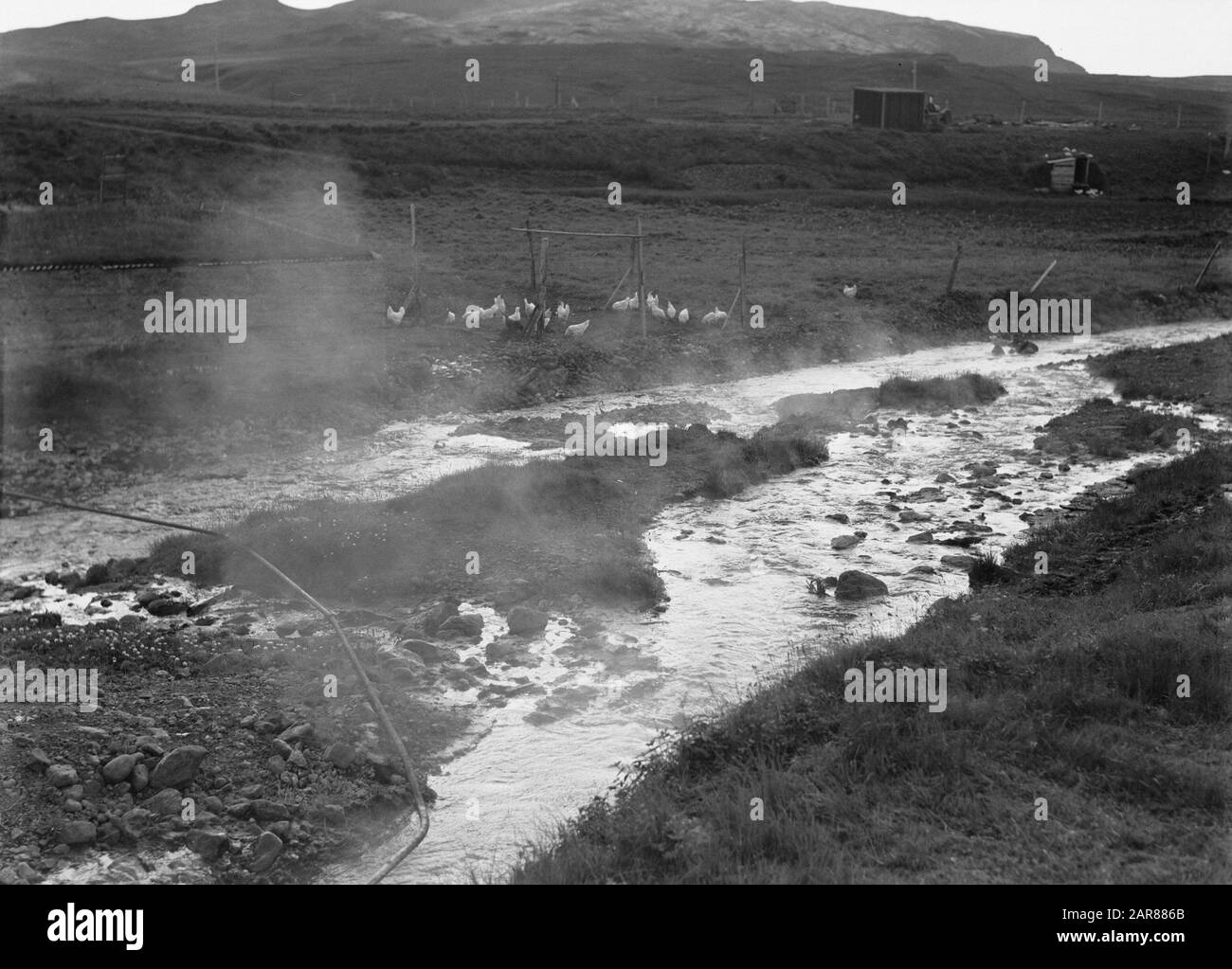 Iceland Reykir. Steam hot spring in the landscape with water pipes Date ...