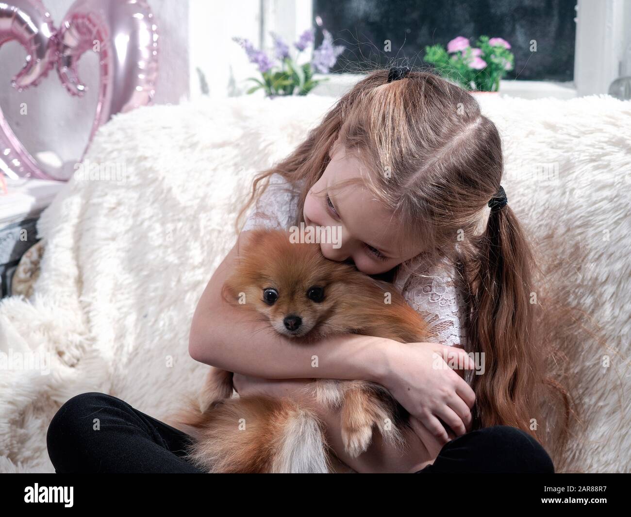 Portrait of a child with a dog in a home interior Stock Photo - Alamy
