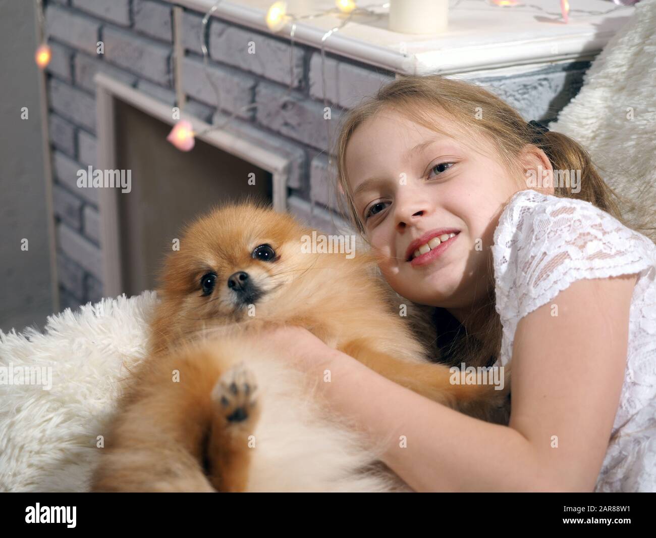 Portrait of a child with a dog in a home interior Stock Photo - Alamy