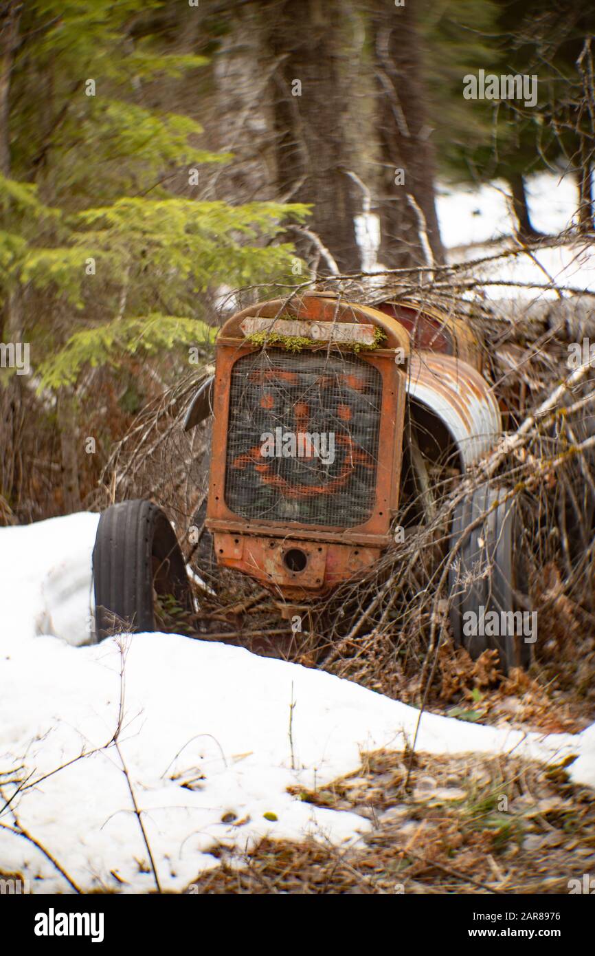 An old, red 1935 McCormick-Deering W30 2WD Tractor in the snow, in a ...