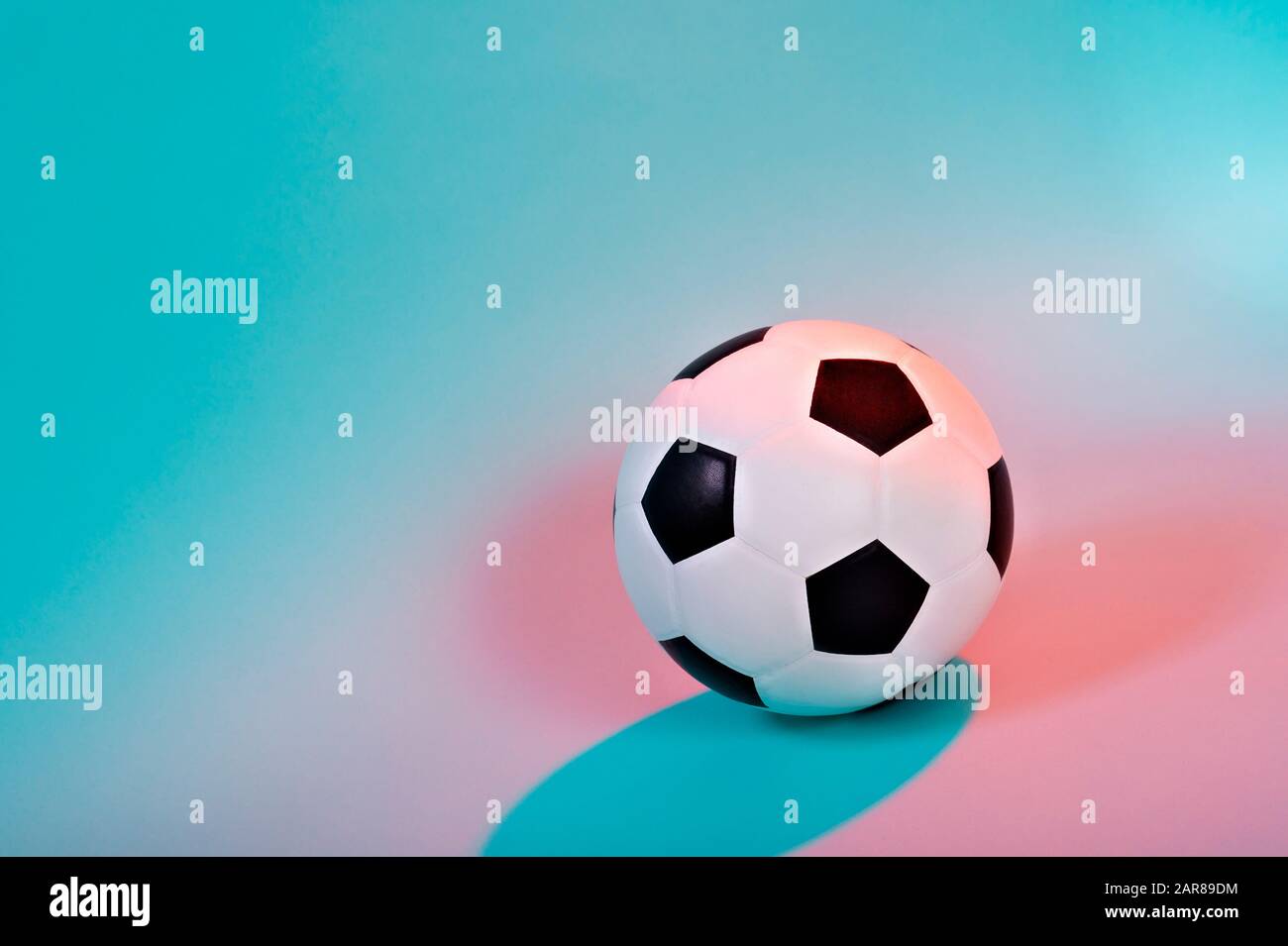 Soccer ball isolated on blue neon background Stock Photo - Alamy