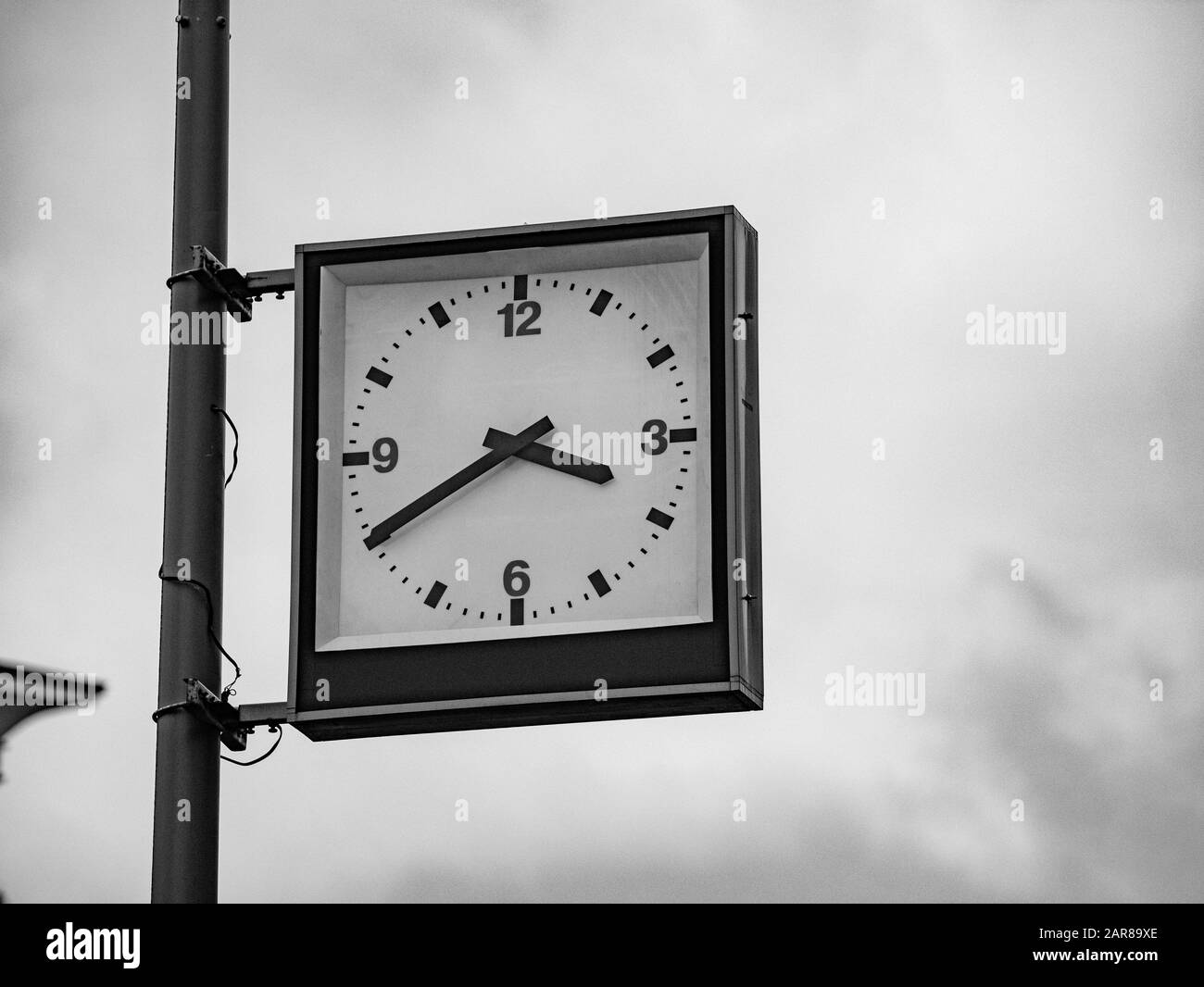 Street clock with a traditional dial and hands arrows for hours and ...