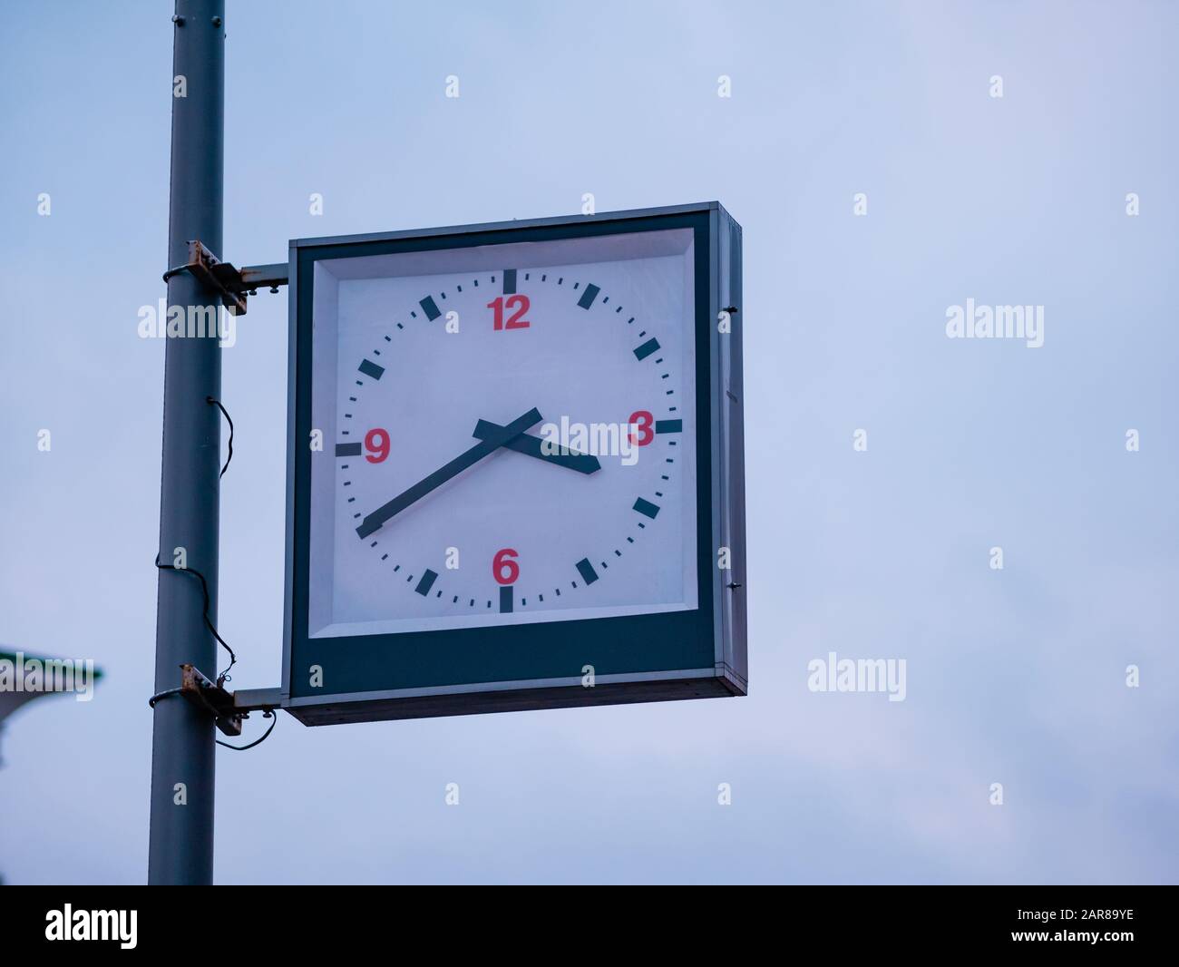 Street clock with a traditional dial and hands arrows for hours and ...