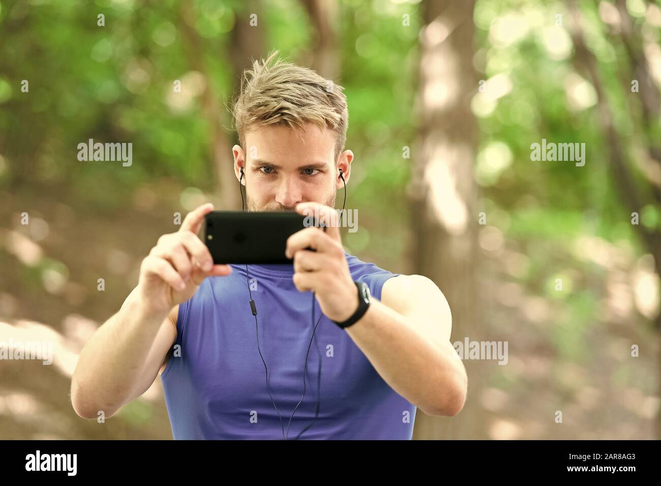 blogging. gadget in modern sport. muscular man in tracker make photo ...