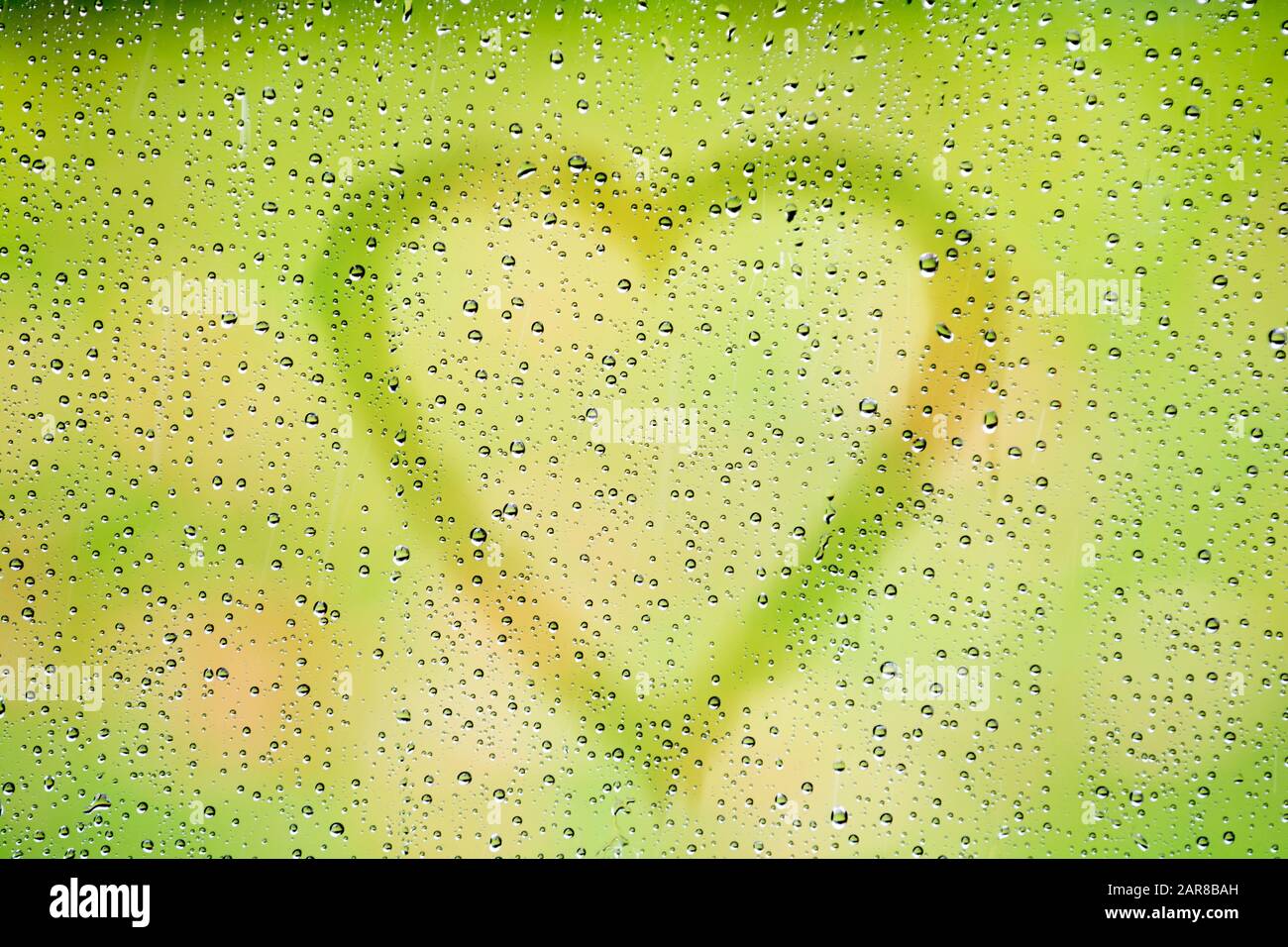 Heart drawn on fogged up glass window with rain as a romantic gesture ...