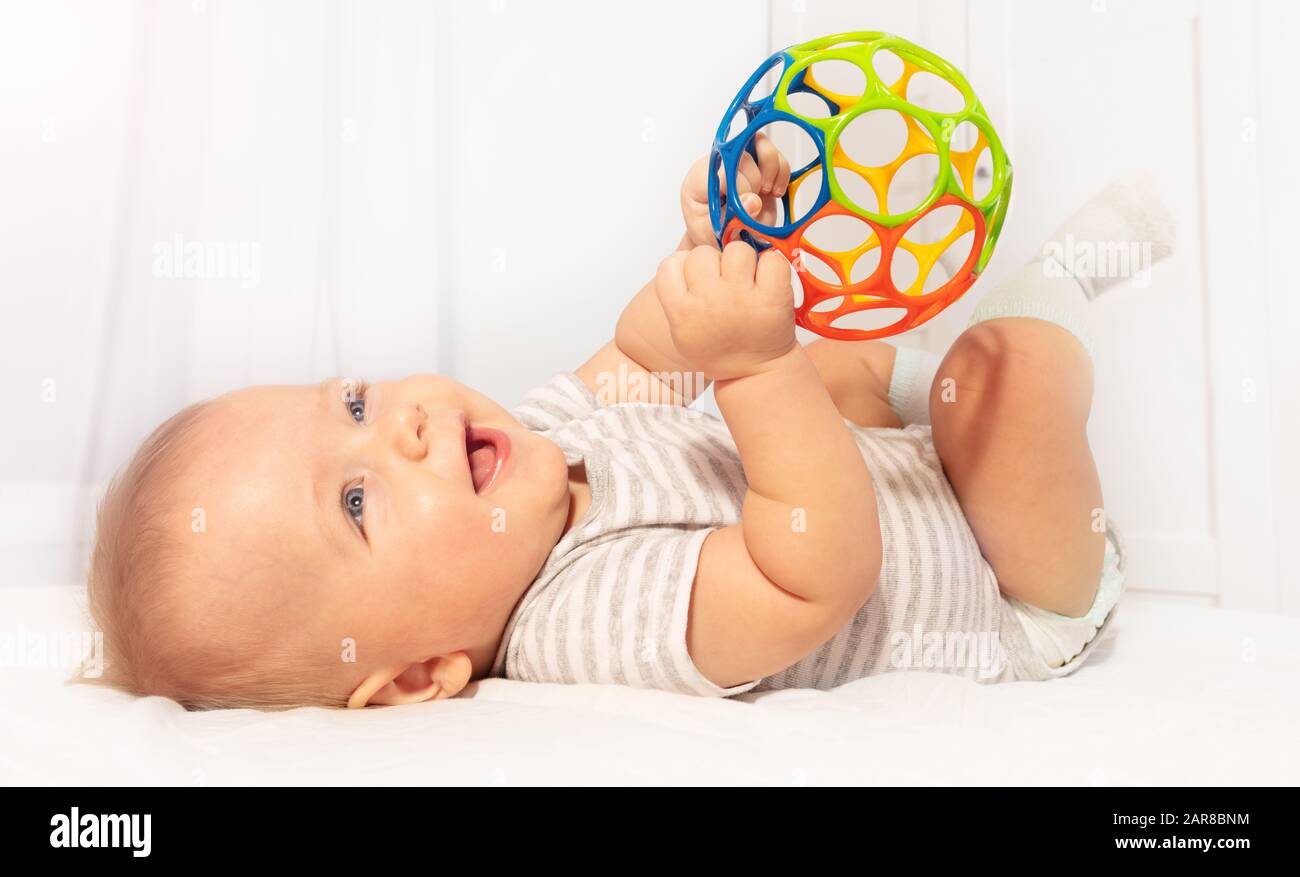 Baby and laying on back and toy hi-res stock photography and images - Alamy