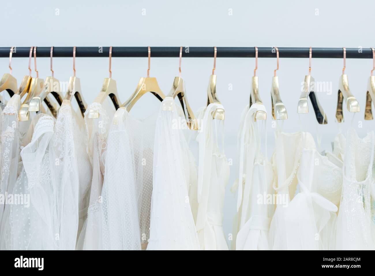 White dresses on hangers Stock Photo - Alamy