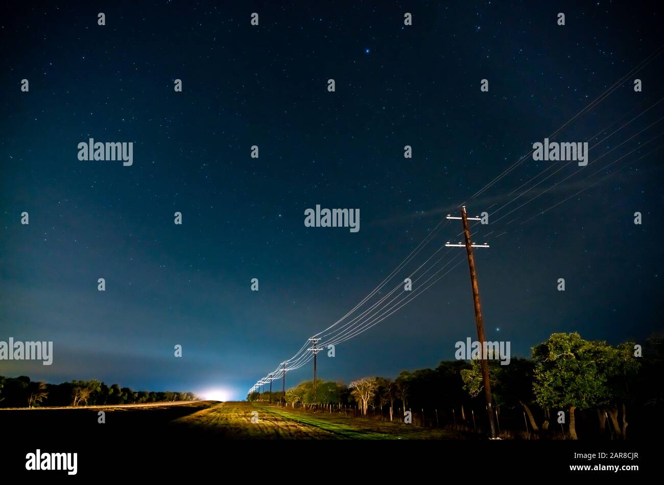 Country Road Illuminated By Traffic in the Night With Stars on Clear ...