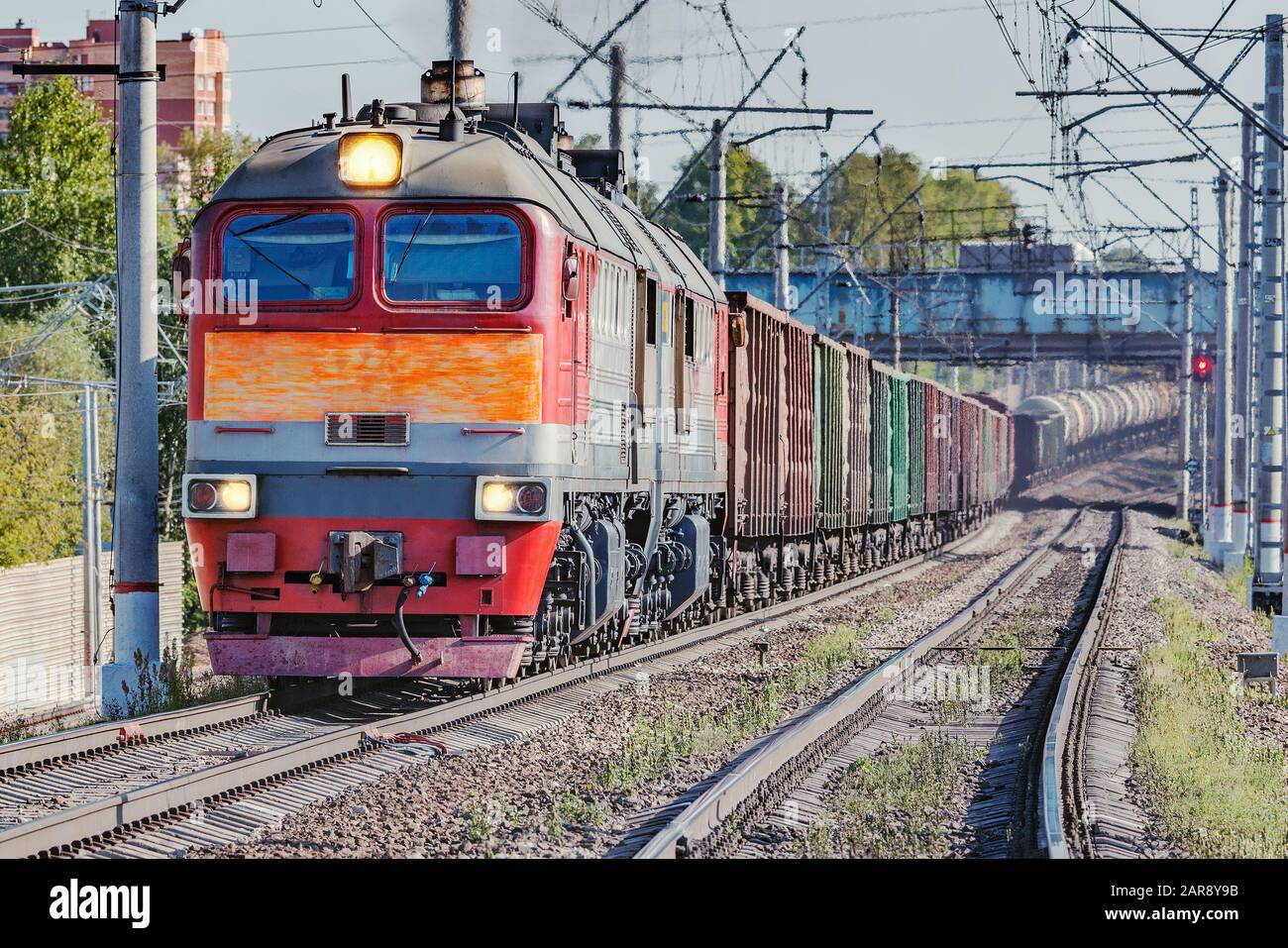 Freight train approaches to the station at morning time Stock Photo - Alamy