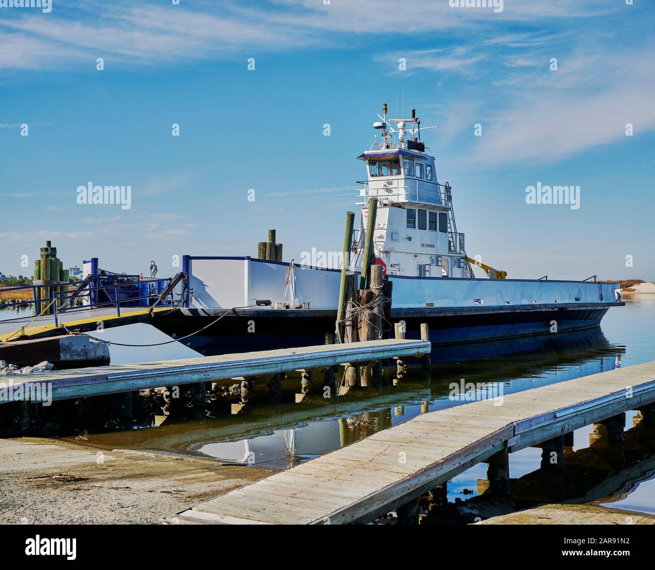 Small empty car ferry waiting to load at the ferry dock on Dauphin ...