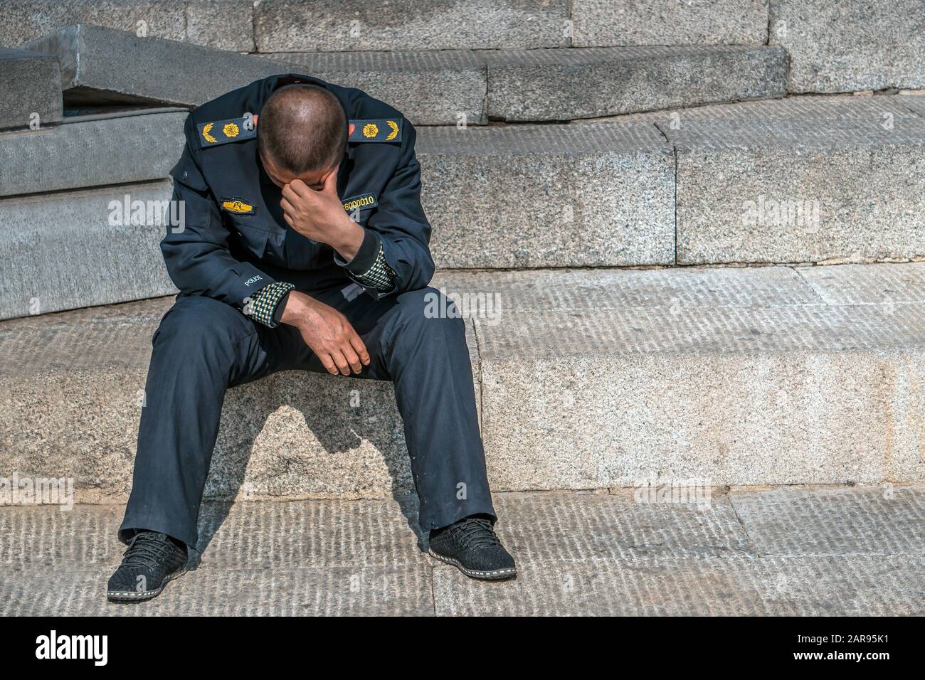 Sad policeman is sitting on the floor with his had down, he lost his ... Sad policeman is sitting on the floor with his had down, he lost his ...