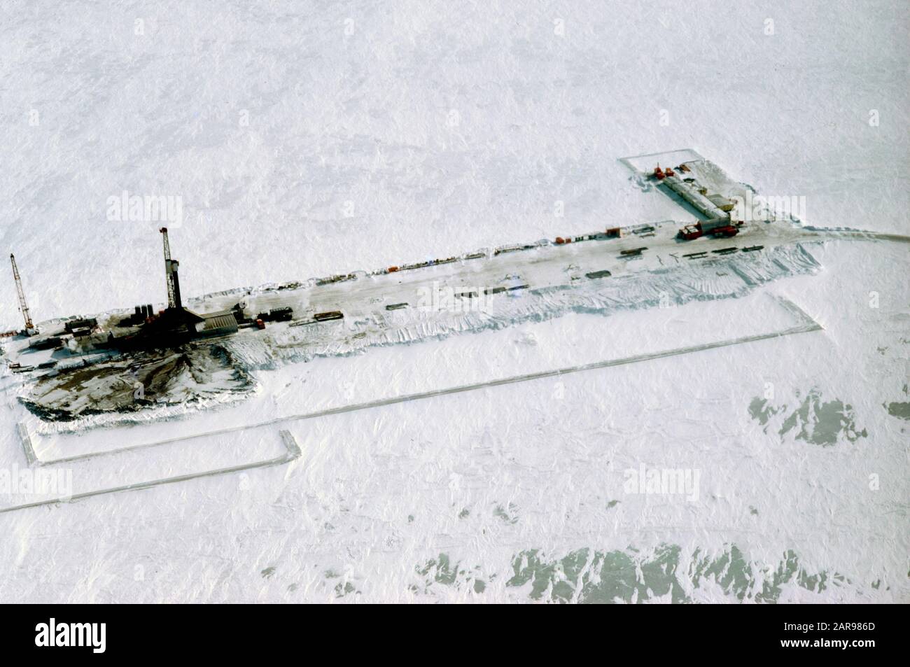 Surrounded by snow and ice, an oil drilling operation operates under ...