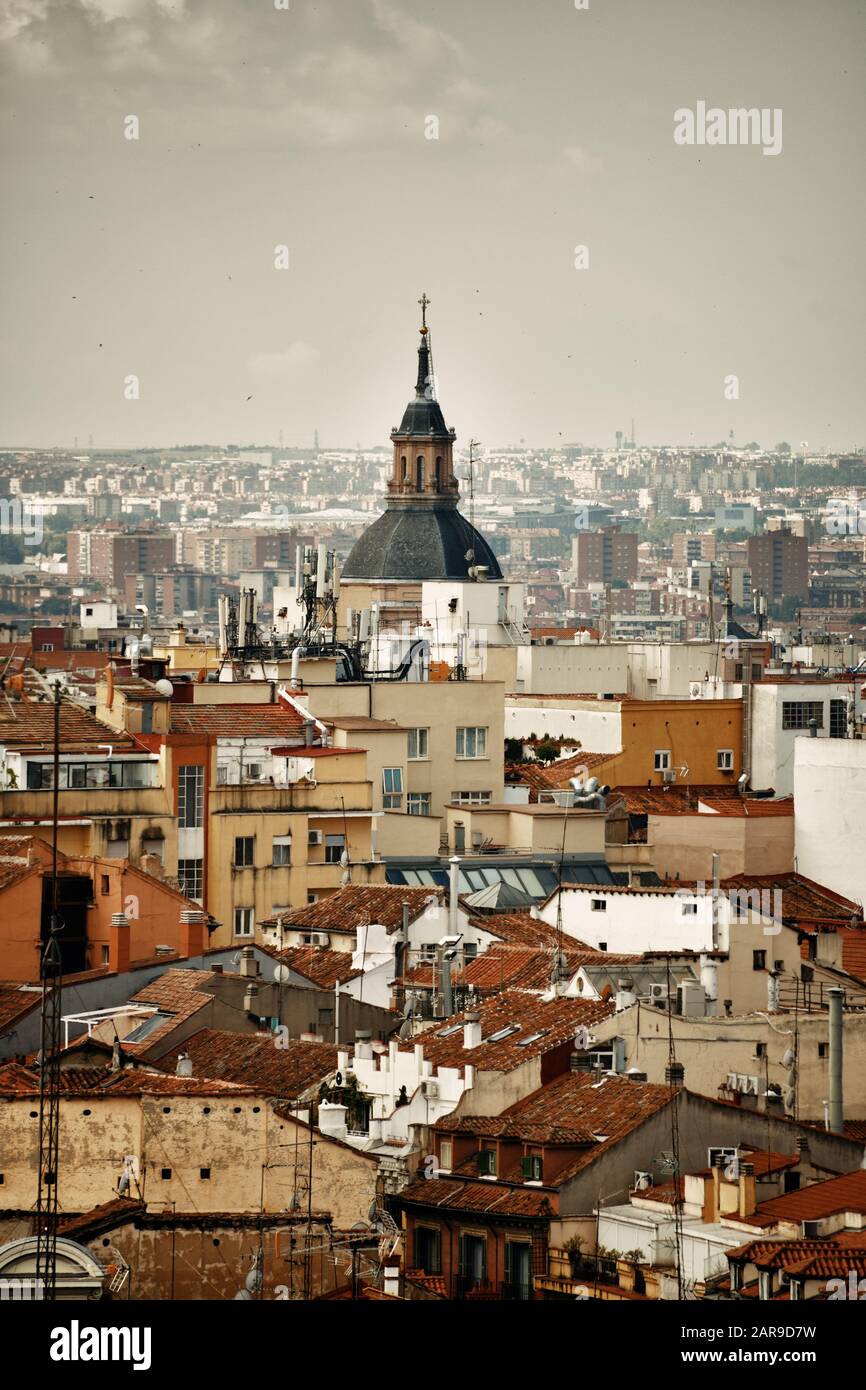 Madrid skyline rooftop view with buildings and church bell tower in ...