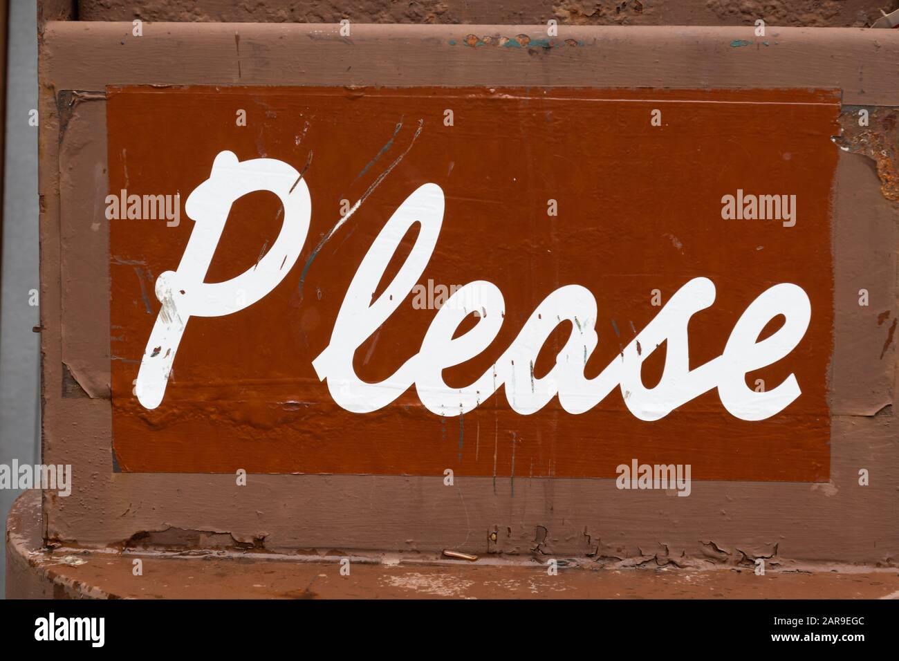 Please Sign painted on to side of brown trash can Stock Photo - Alamy