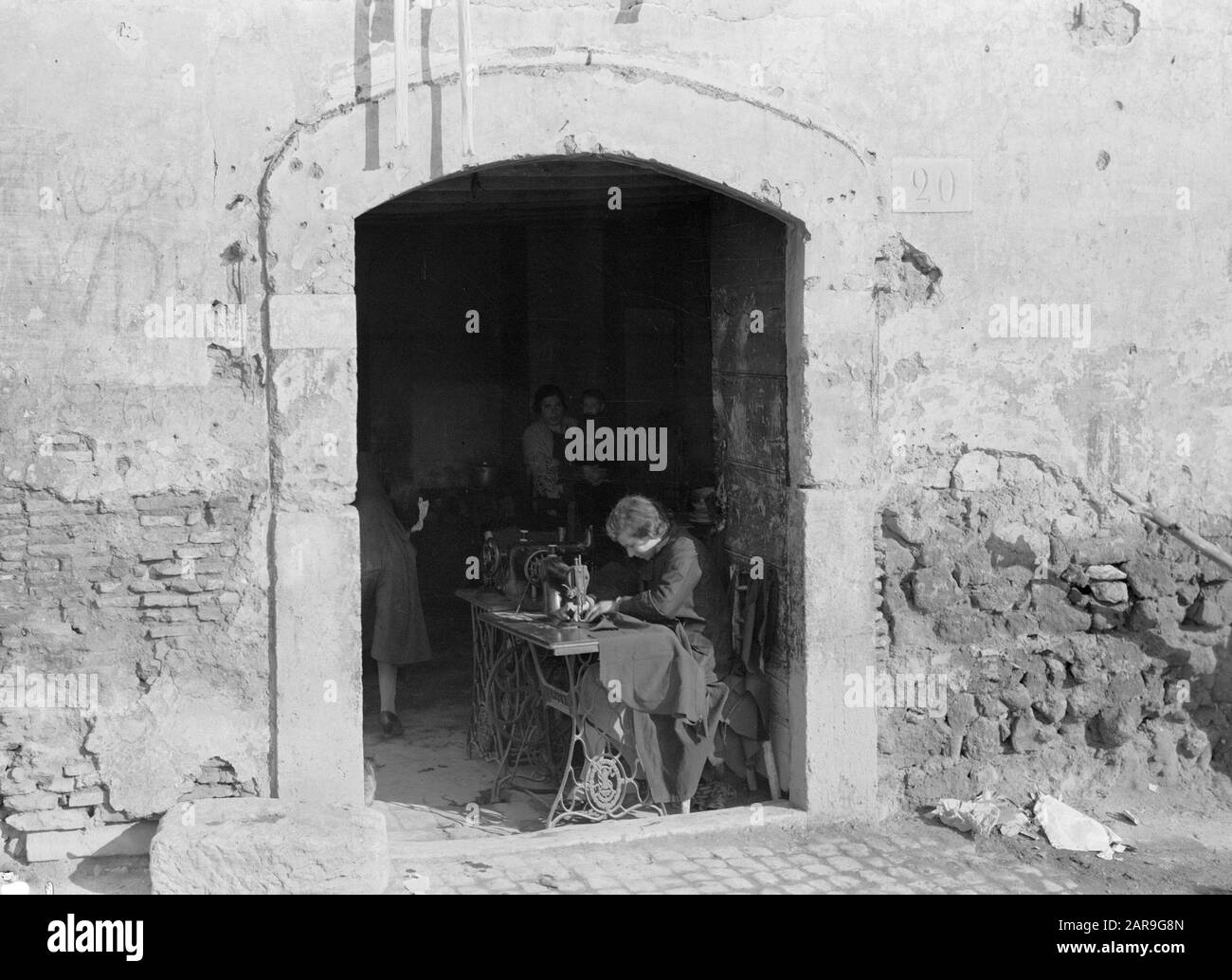 Rome: Visit to the city Woman sits in a doorway behind a sewing machine ...