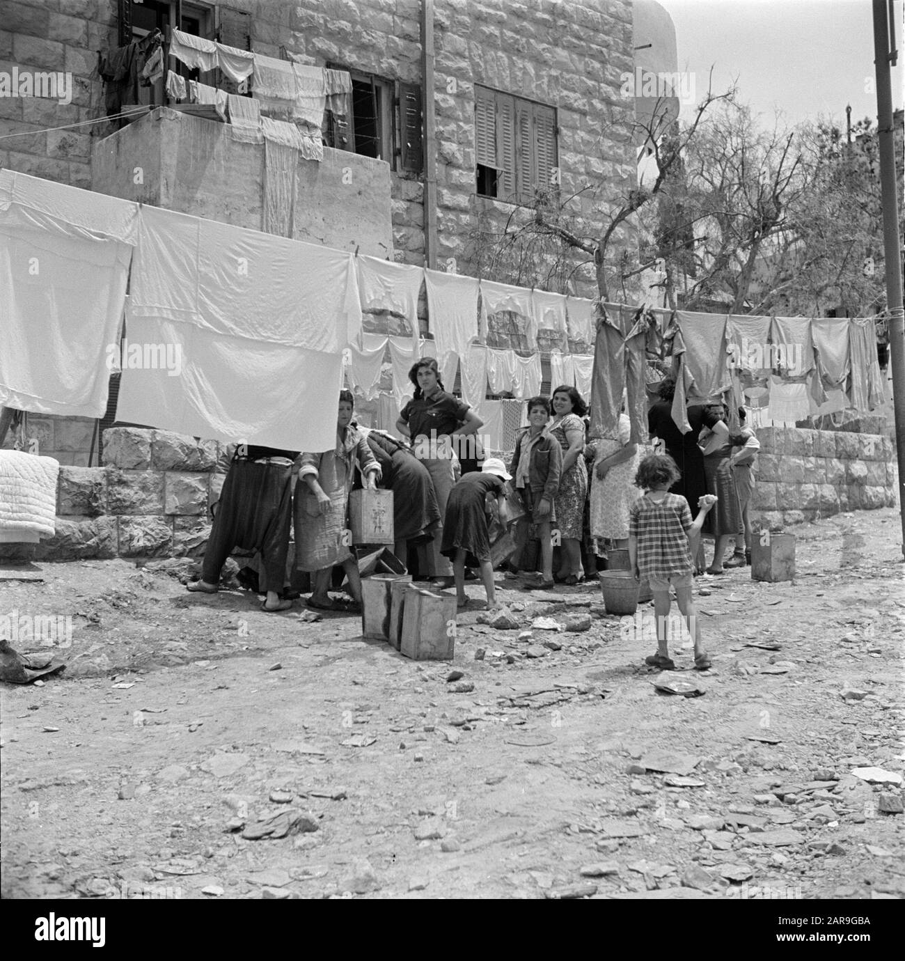 Israel 1948-1949: Jerusalem Women and children at a water source, under ...