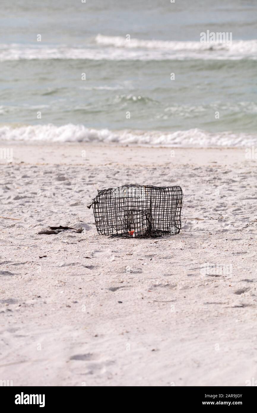 Crab and lobster trap washed up on the white sand beach of Tigertail ...