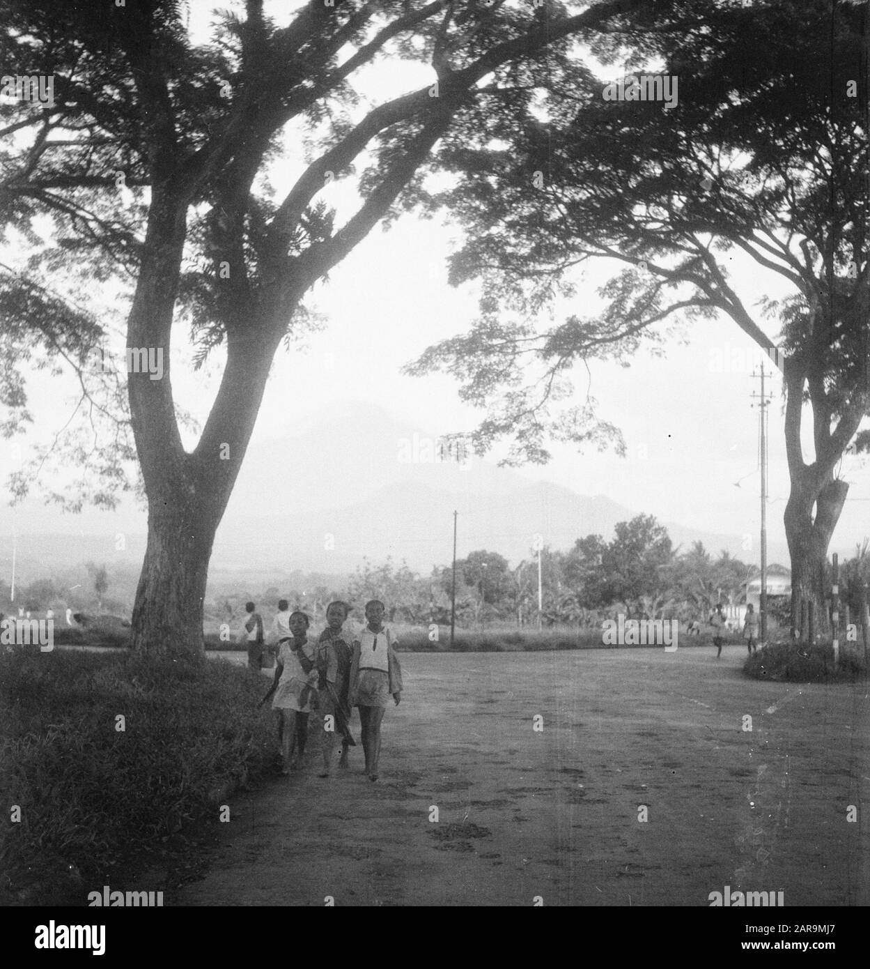 Magelang en surroundings [View of T-junction. Children walk along the ...