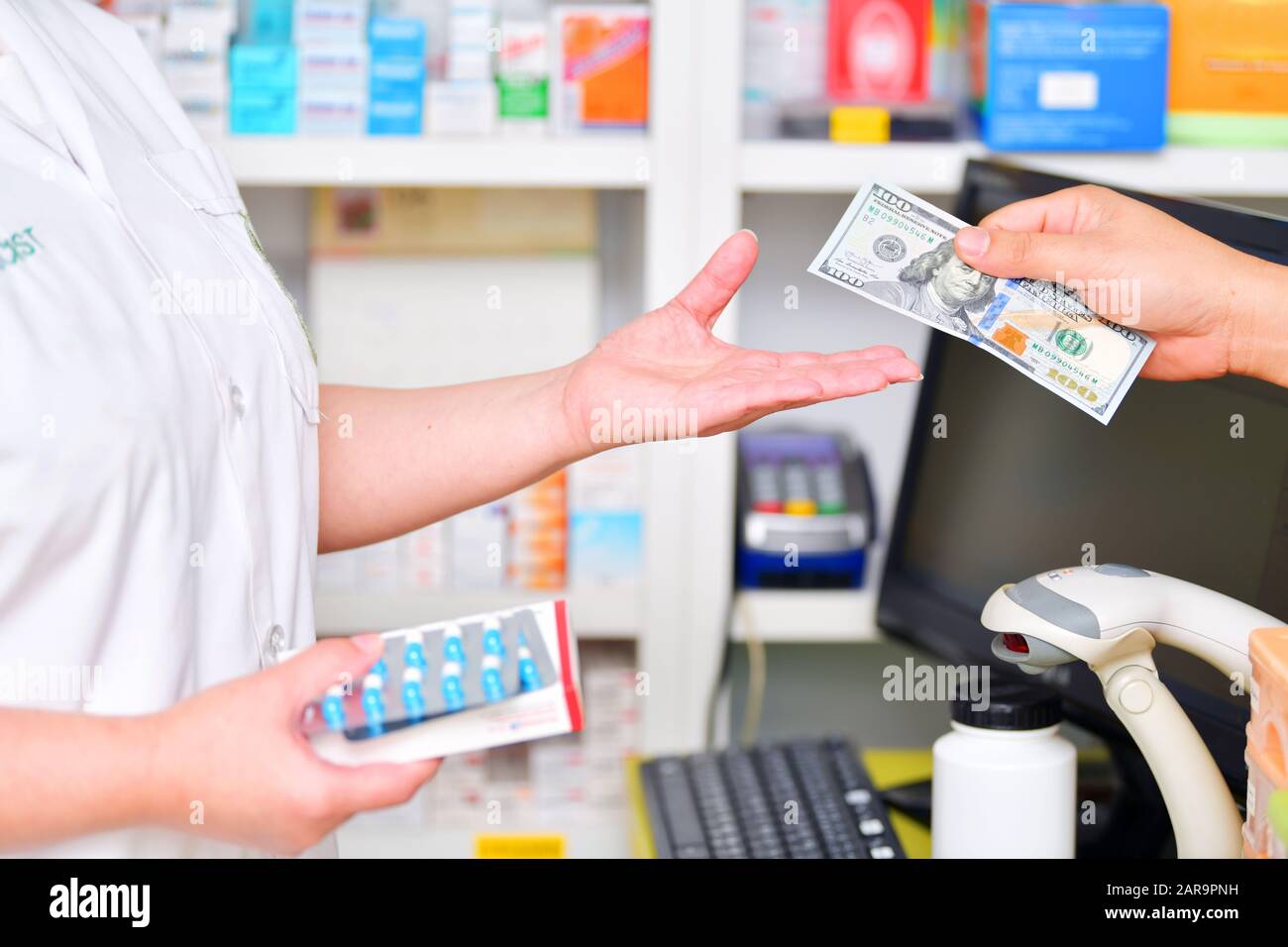Customer paying for Medicaments with 100 dollar bill in pharmacy ...