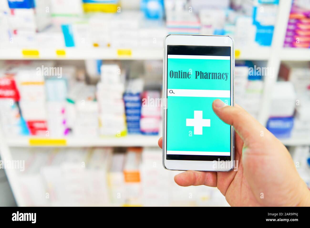 Pharmacist using mobile smart phone for search bar on display in ...