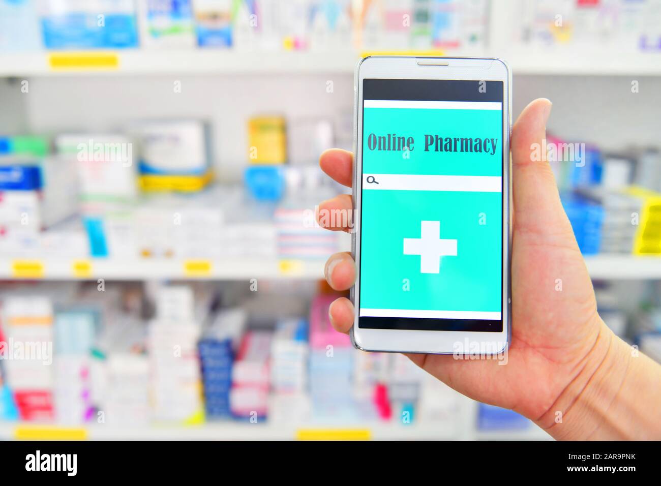 Pharmacist using mobile smart phone for search bar on display in ...