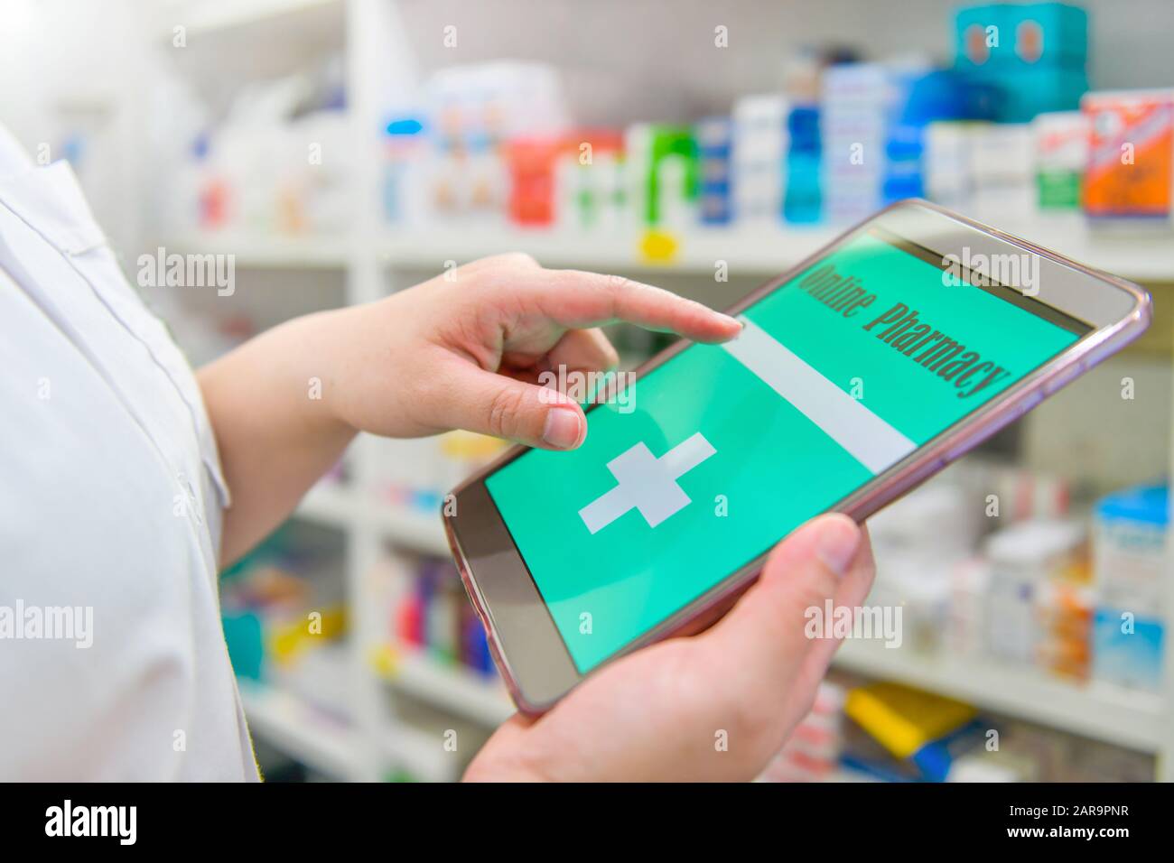 Doctor using computer tablet for search bar on display in pharmacy ...