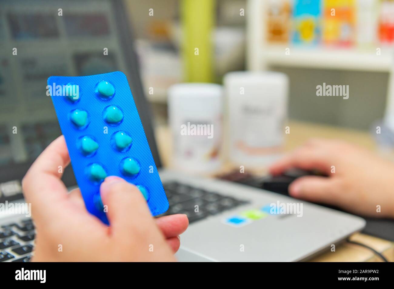 Pharmacist using the computer laptop in chemist shop or pharmacy drug ...